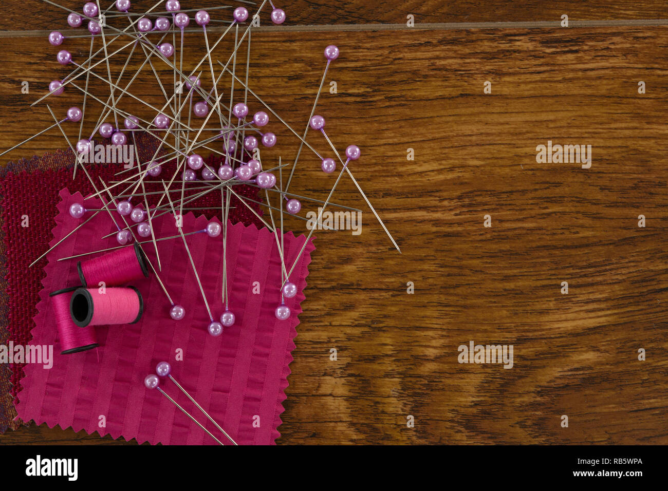 Thread rolls, sewing pins and textile Stock Photo - Alamy