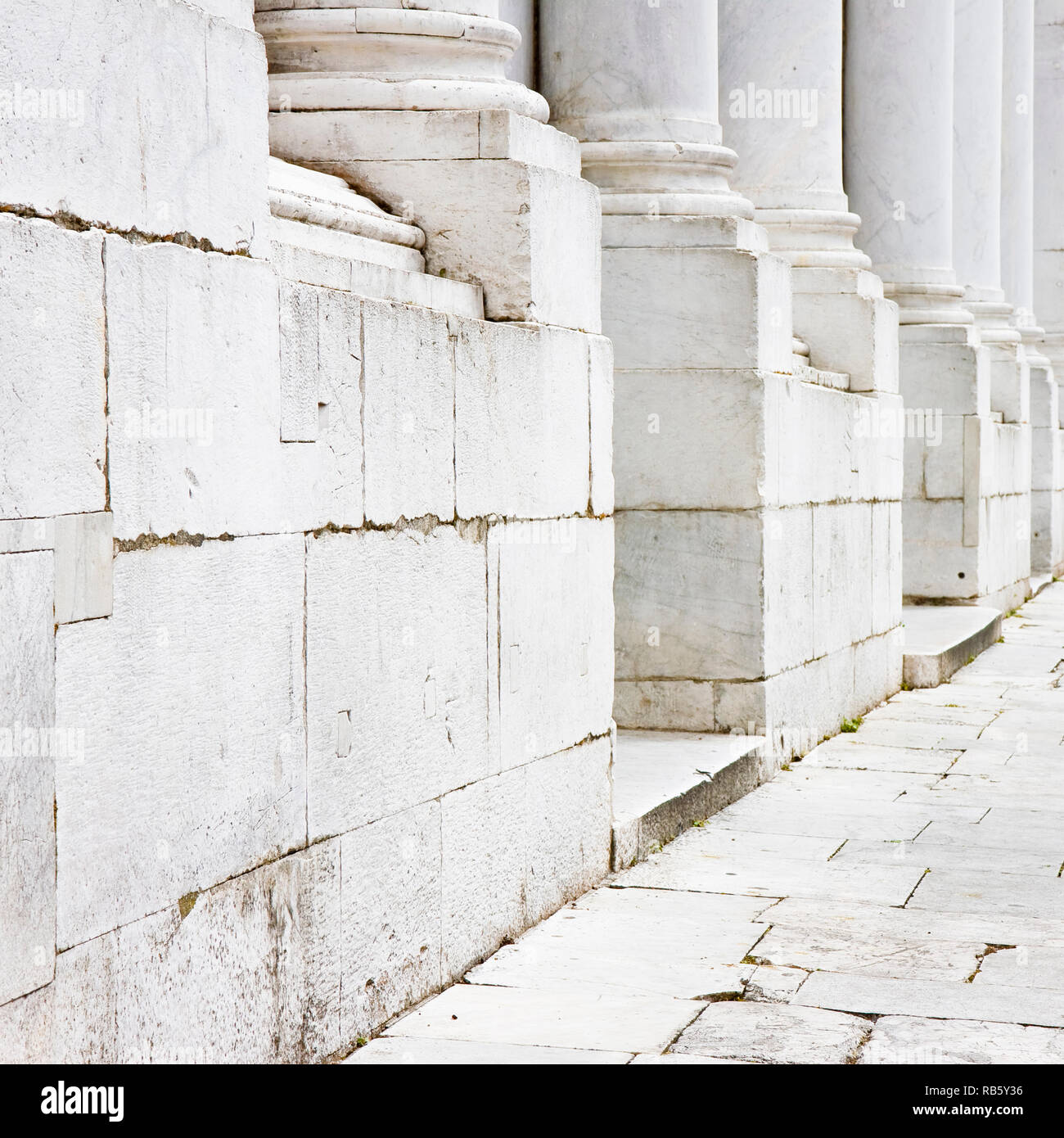 Base of the marble columns of a romanesque Italian church Stock Photo ...