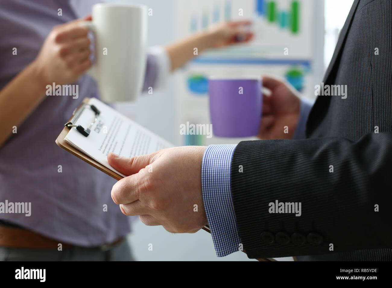 Group of people deliberate on white board Stock Photo - Alamy
