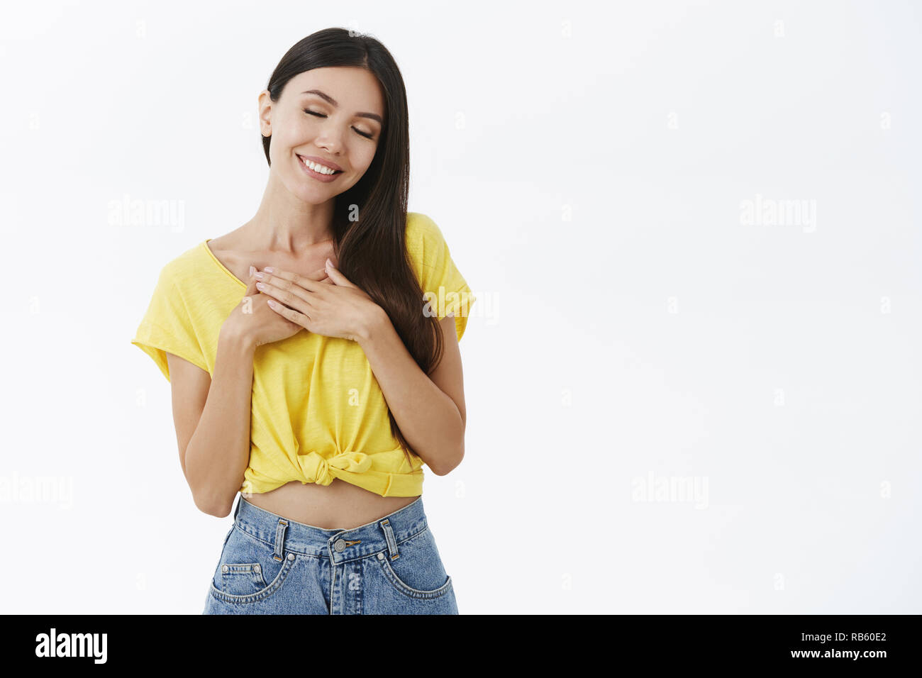 Tender touched attractive slim woman with long dark hair closing eyes ...