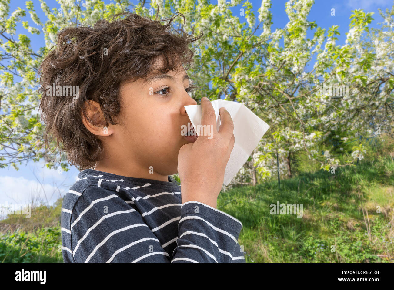 Boy blowing nose Stock Photo - Alamy