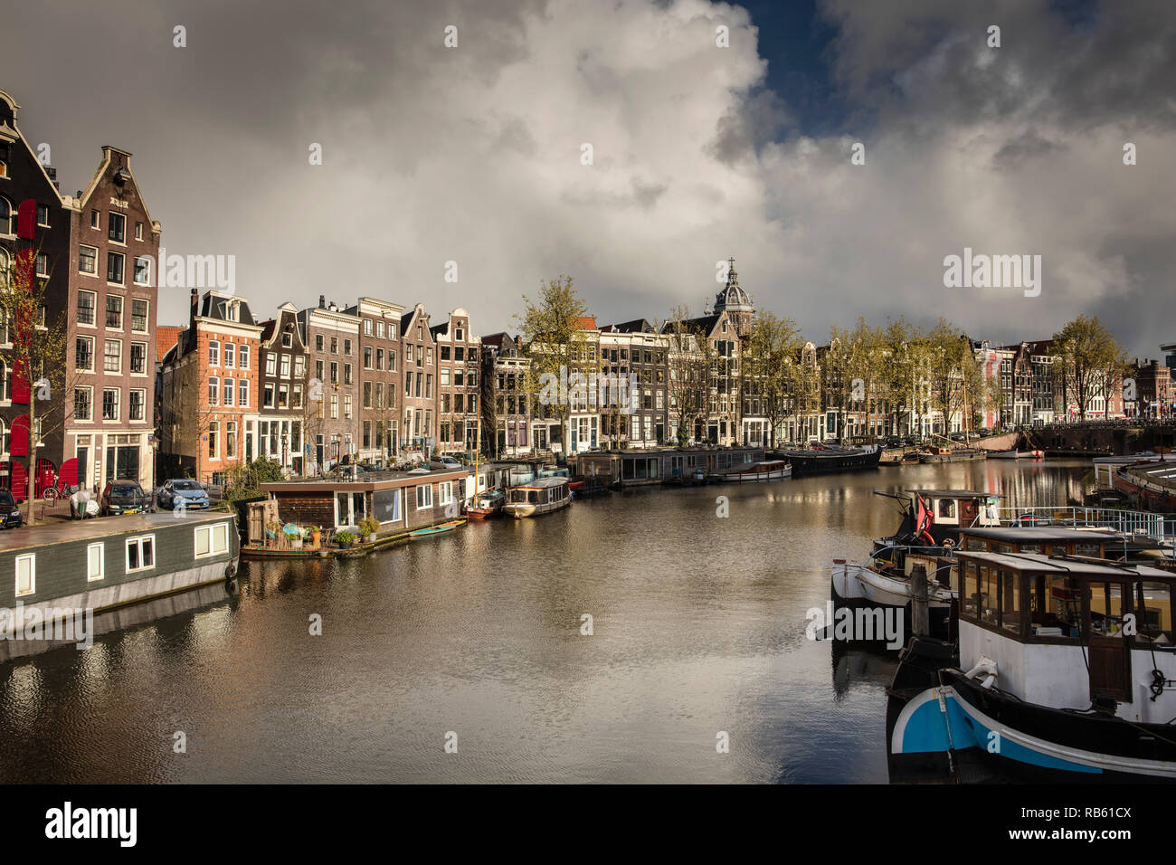 The Netherlands, Amsterdam, View on canal houses and houseboats in ...