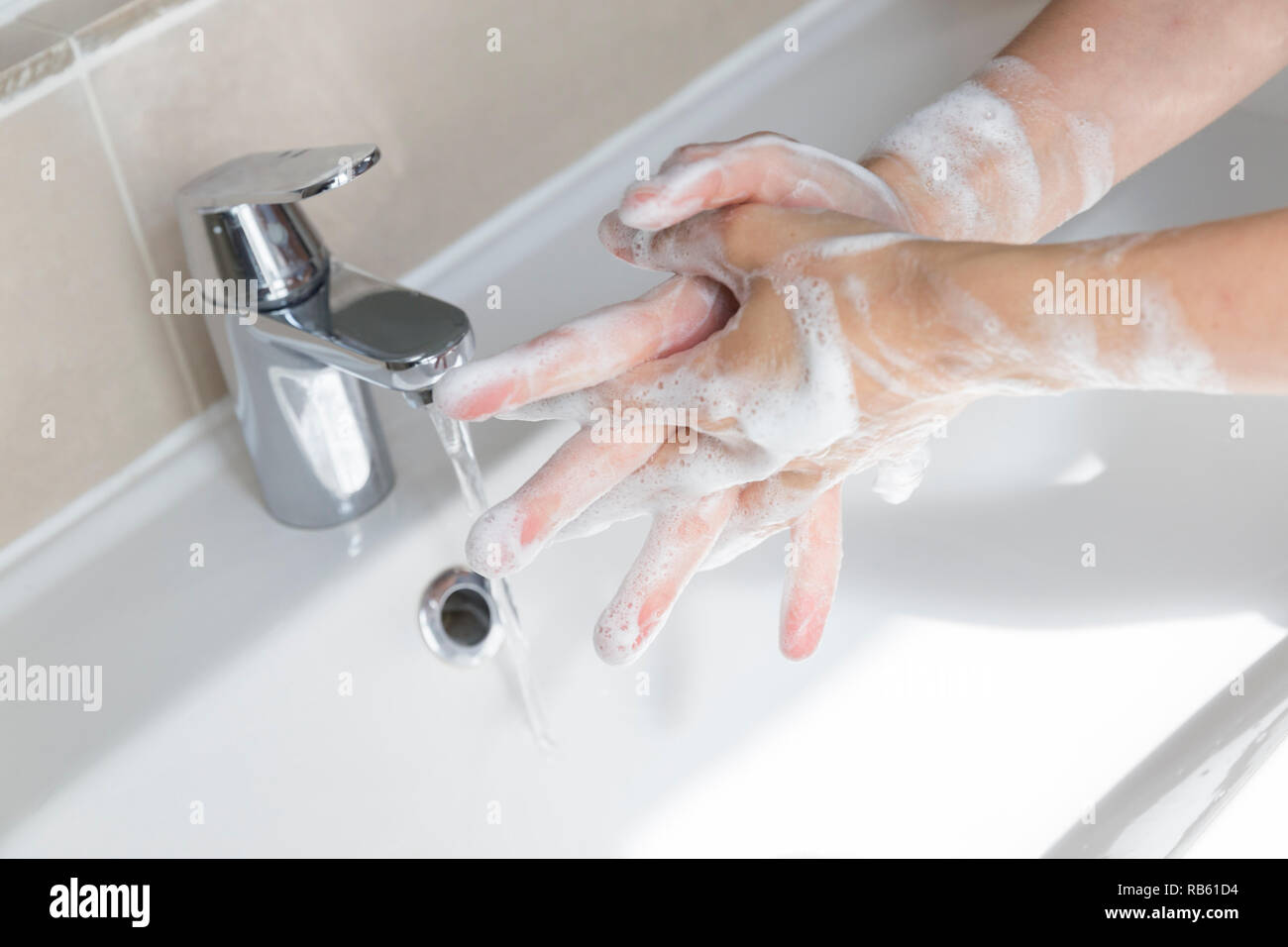 A woman suffering from contamination OCD: obsessive hand washing Stock ...