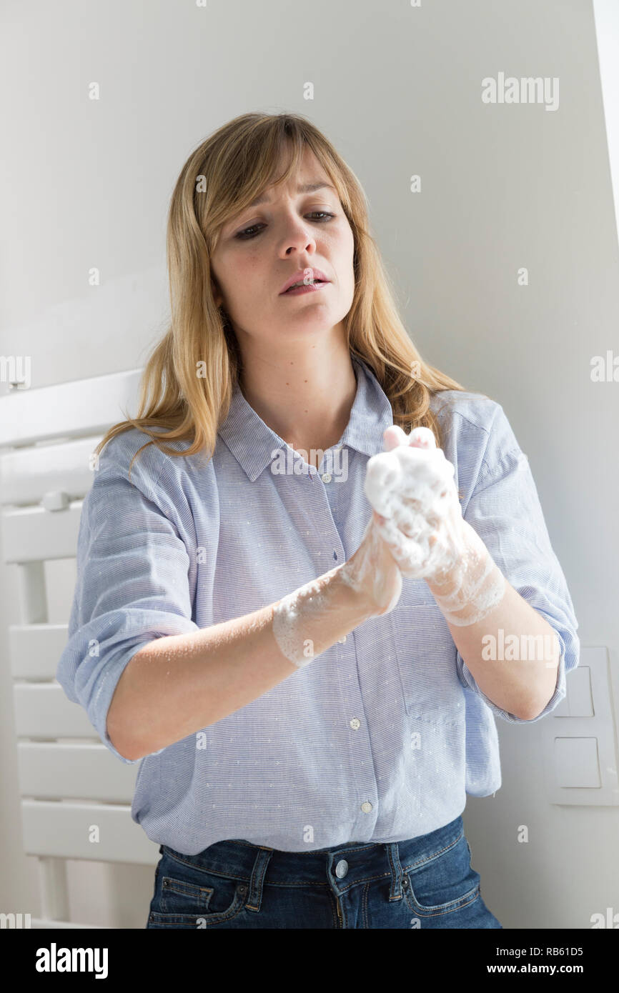 A woman suffering from contamination OCD: obsessive hand washing Stock ...