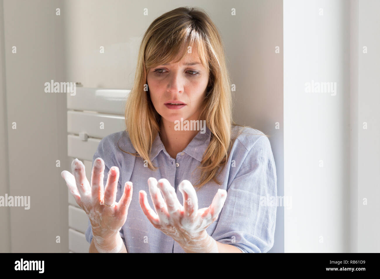 A woman suffering from contamination OCD: obsessive hand washing Stock ...
