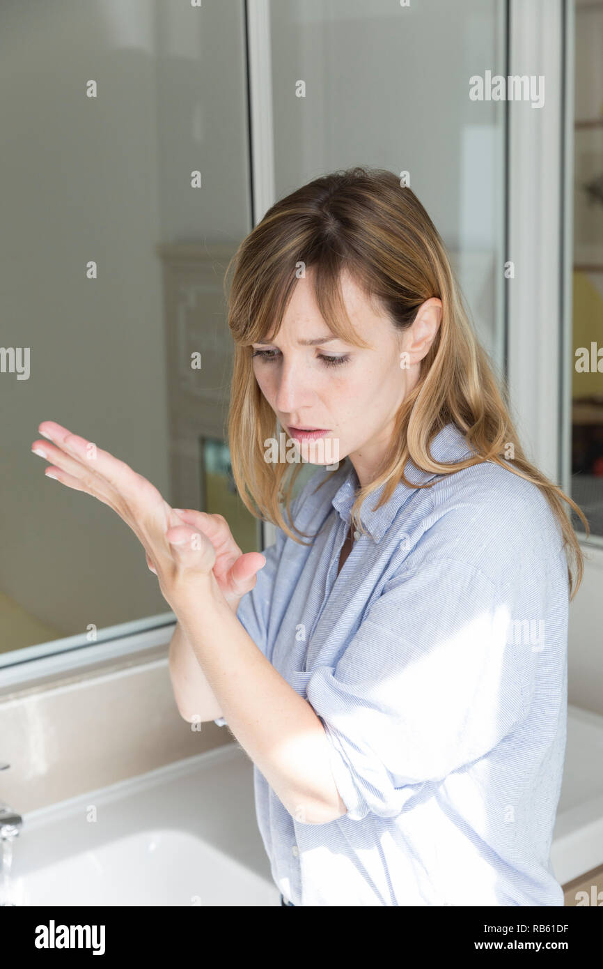 A woman suffering from contamination OCD: obsessive hand washing Stock ...
