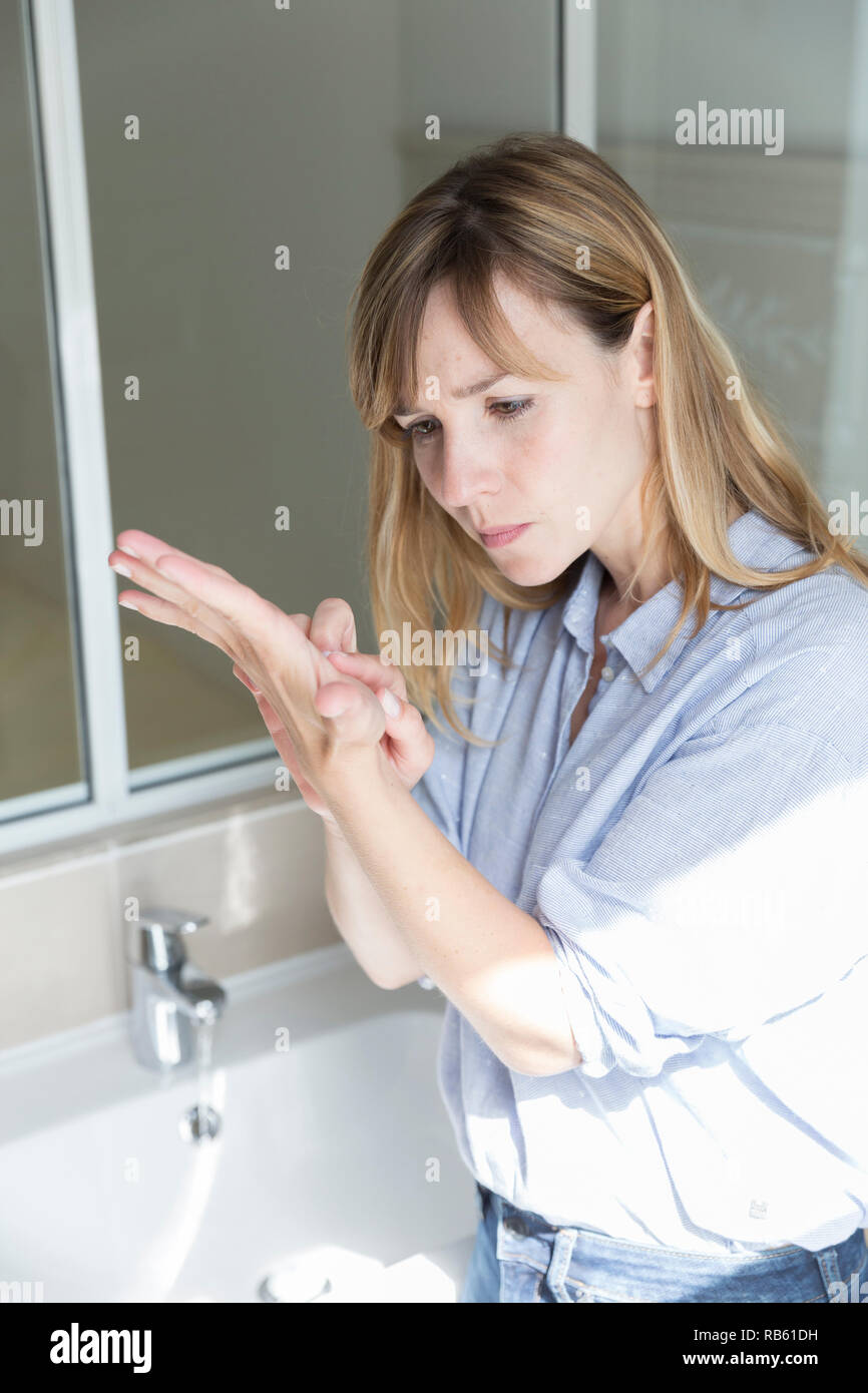 A woman suffering from contamination OCD: obsessive hand washing Stock ...