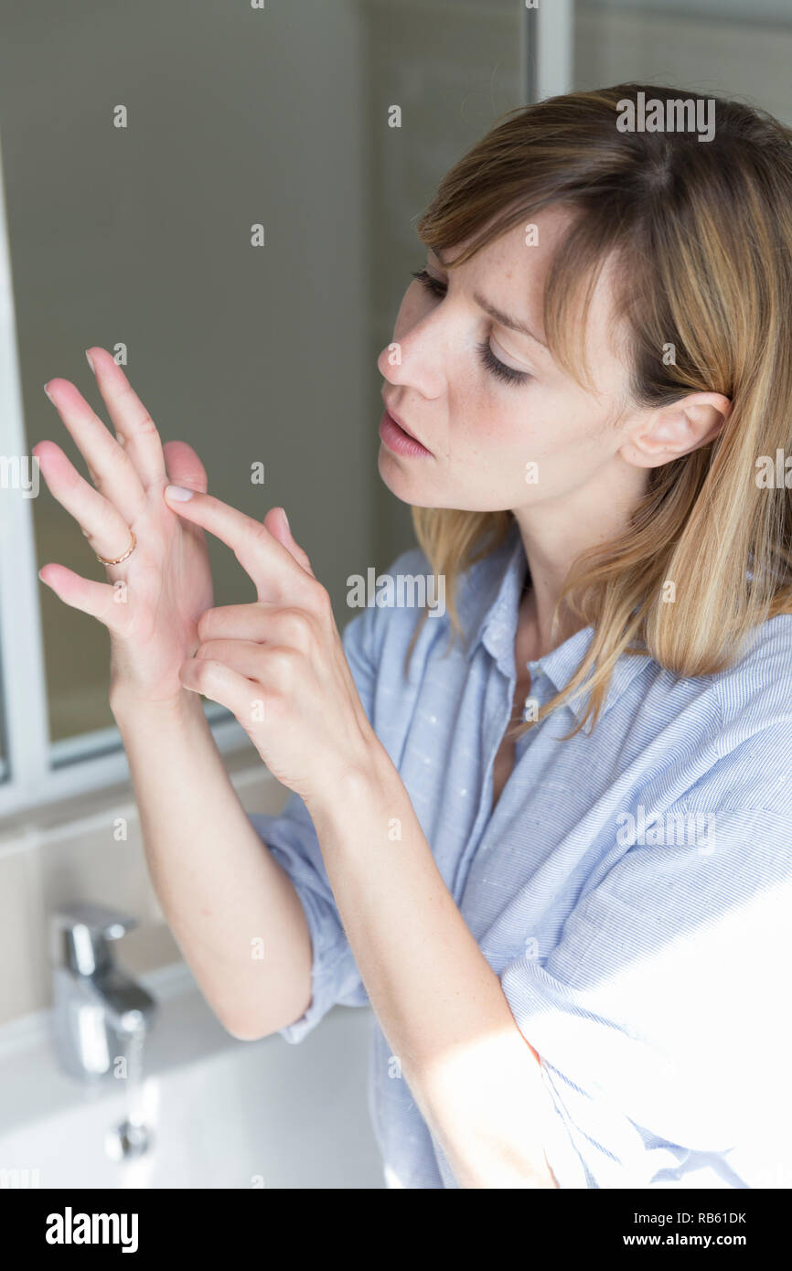 A woman suffering from contamination OCD: obsessive hand washing Stock ...