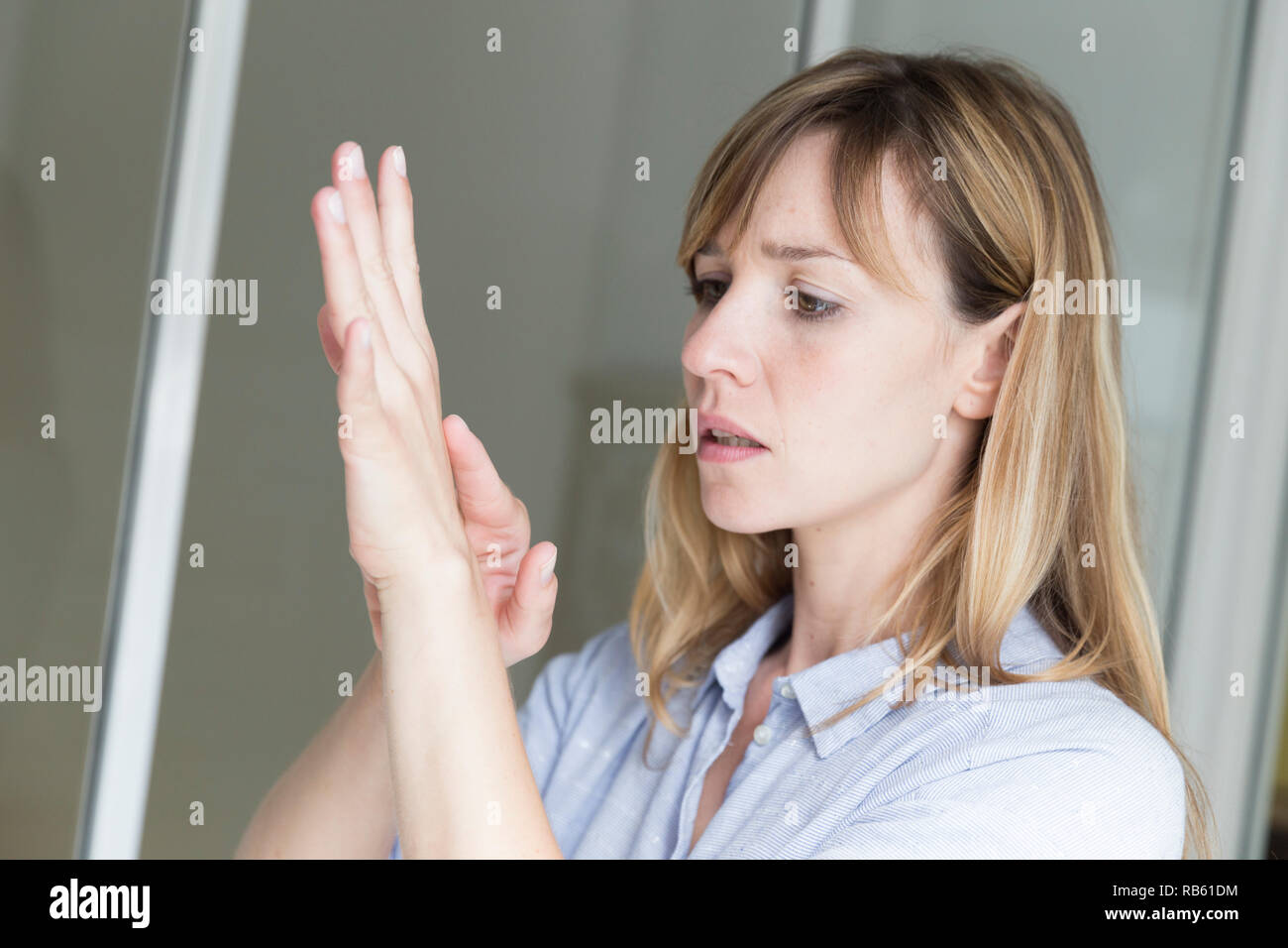 A woman suffering from contamination OCD: obsessive hand washing Stock ...