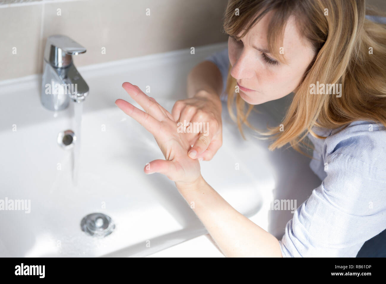 A woman suffering from contamination OCD: obsessive hand washing Stock ...