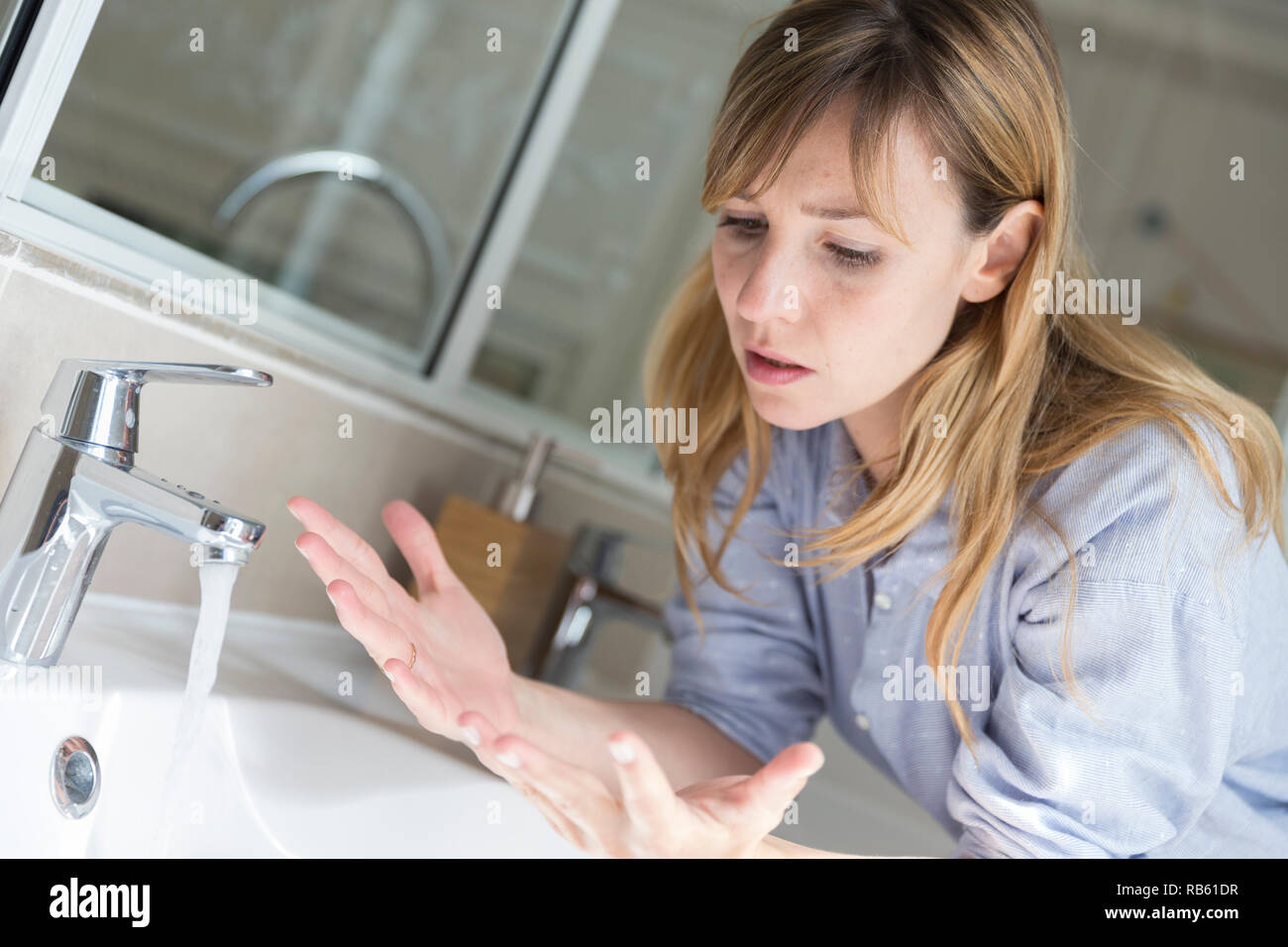 A woman suffering from contamination OCD: obsessive hand washing Stock ...