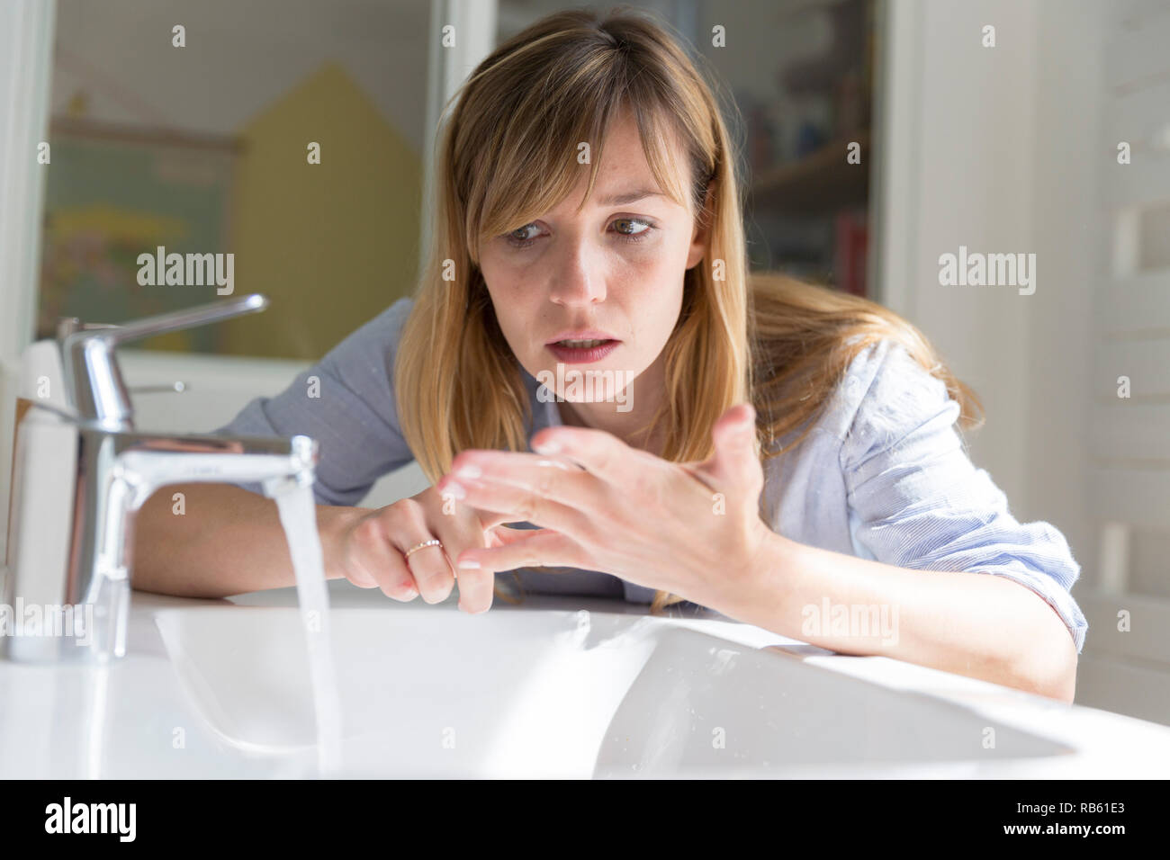 A woman suffering from contamination OCD: obsessive hand washing Stock ...