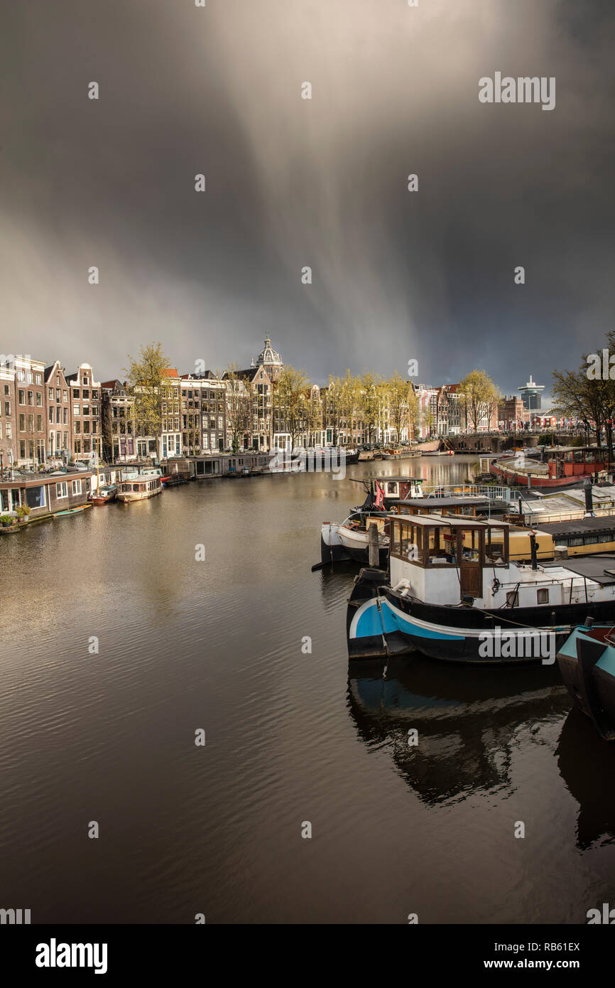 The Netherlands, Amsterdam, View on canal houses and houseboats in ...