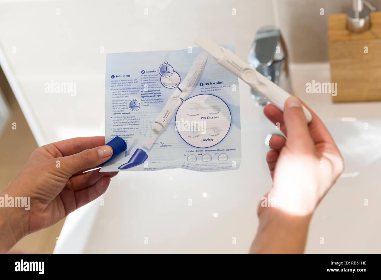 Woman reading the instructions for a pregnancy test Stock Photo - Alamy