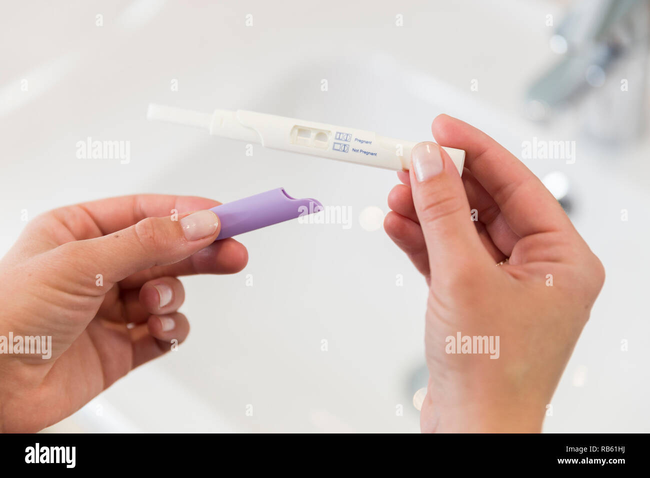 Woman holding a pregnancy test Stock Photo - Alamy