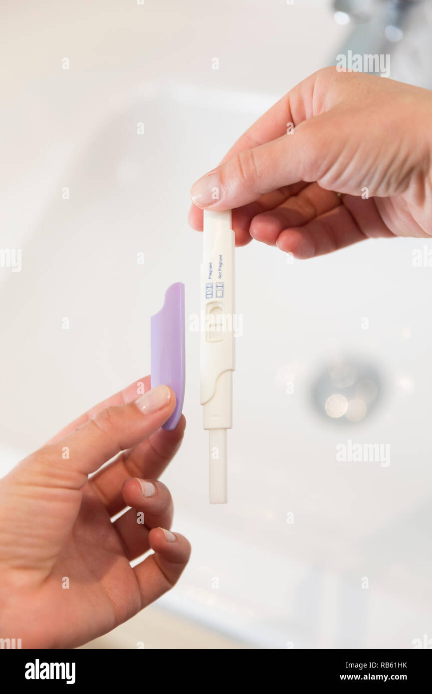 Woman holding a pregnancy test Stock Photo - Alamy