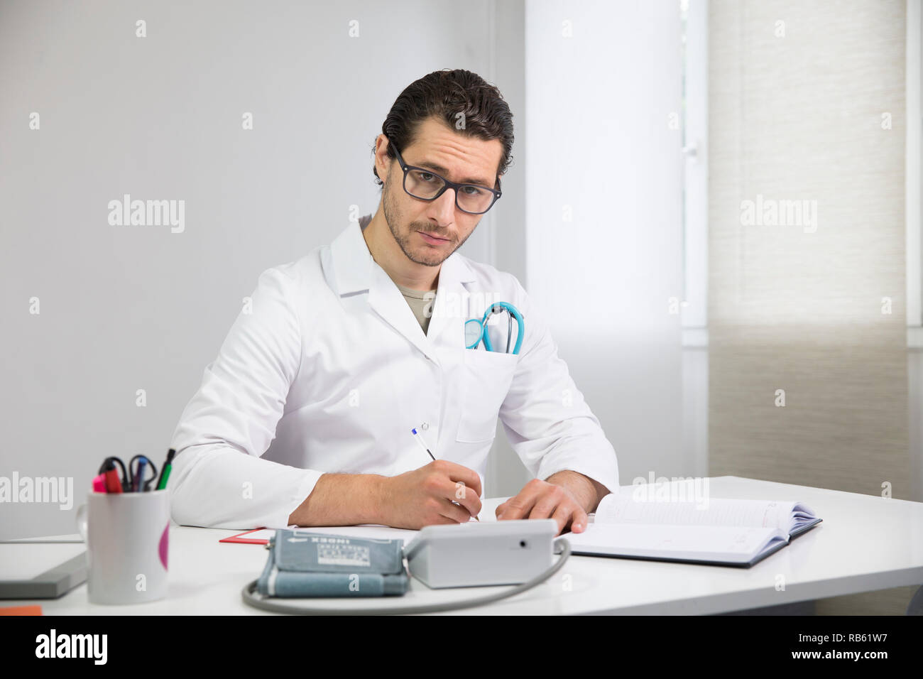 Doctor at his desk Stock Photo - Alamy