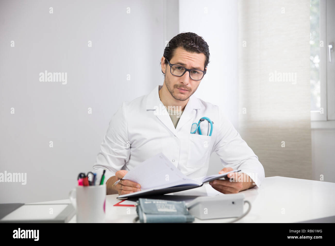 Doctor at his desk Stock Photo - Alamy