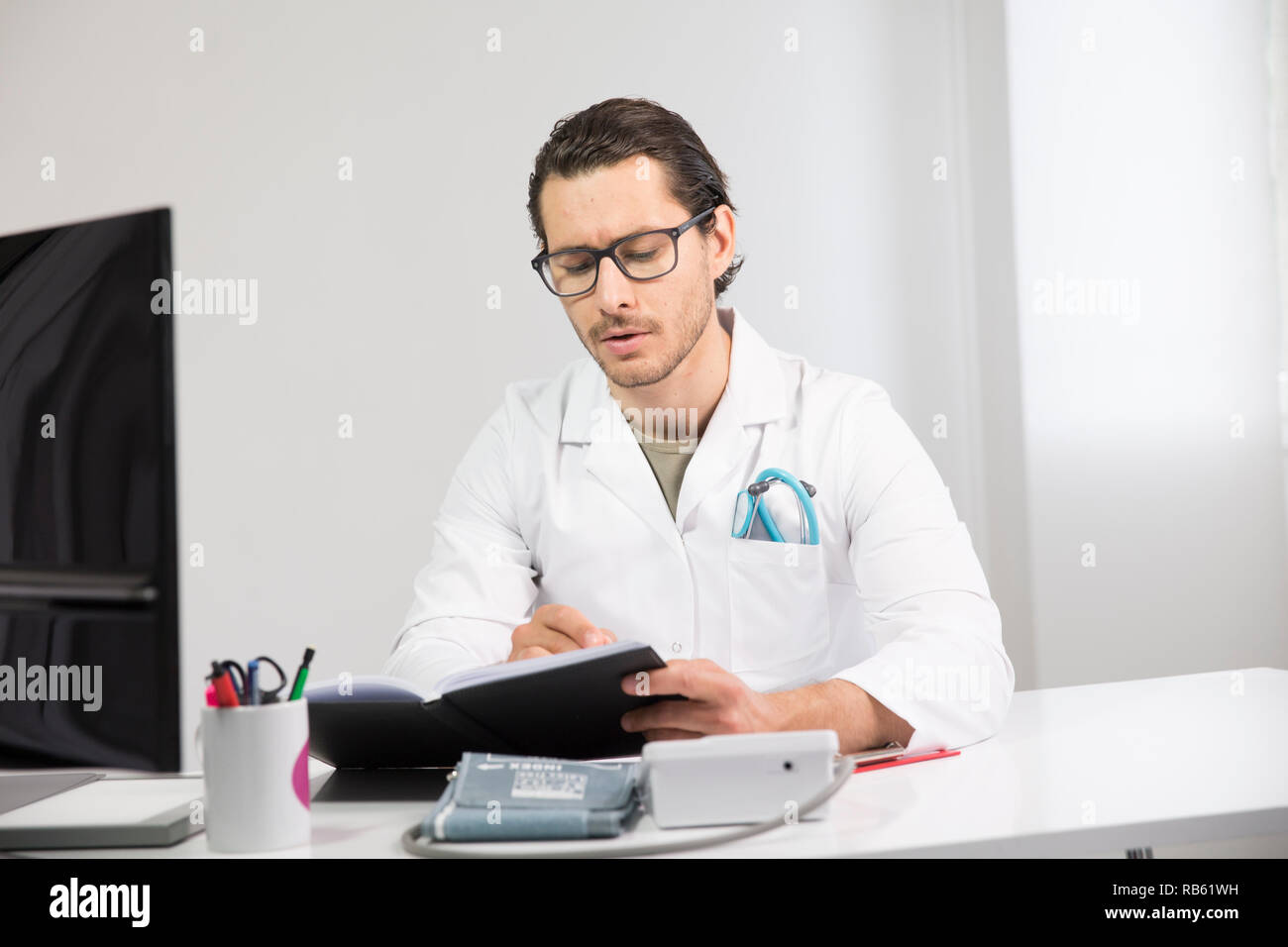 Doctor in front of laptop Stock Photo - Alamy