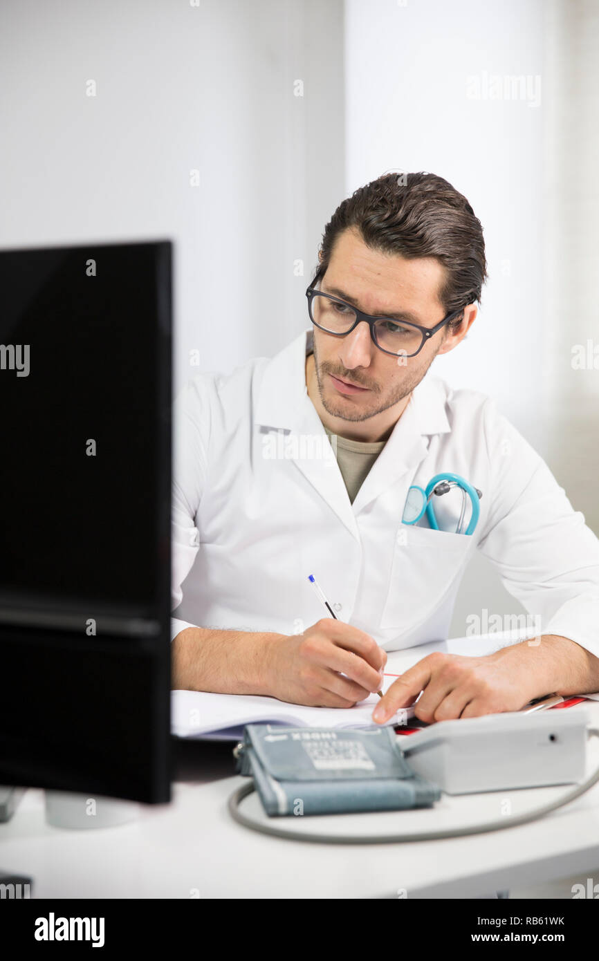 Doctor in front of laptop Stock Photo - Alamy