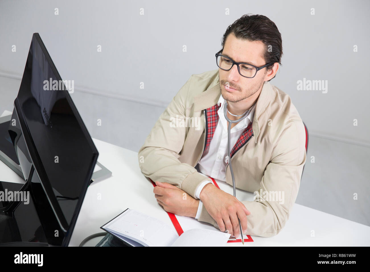 Doctor in front of laptop Stock Photo - Alamy