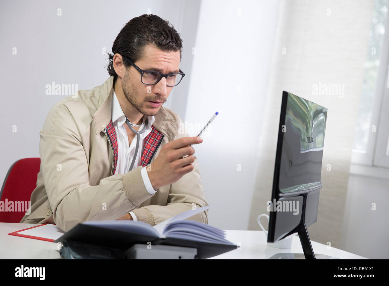 Doctor in front of laptop Stock Photo - Alamy
