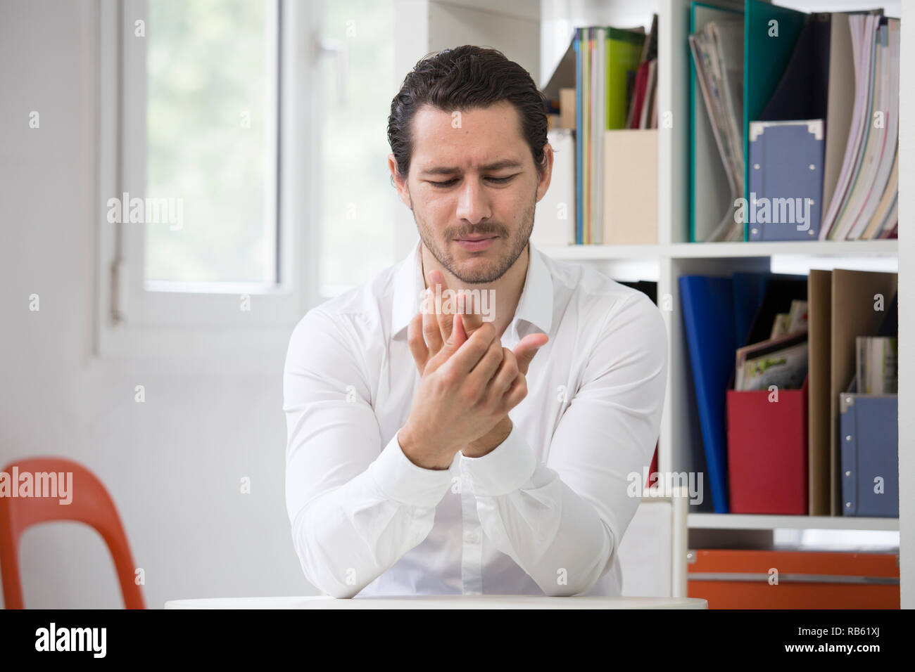 Man suffering from hand pain Stock Photo - Alamy