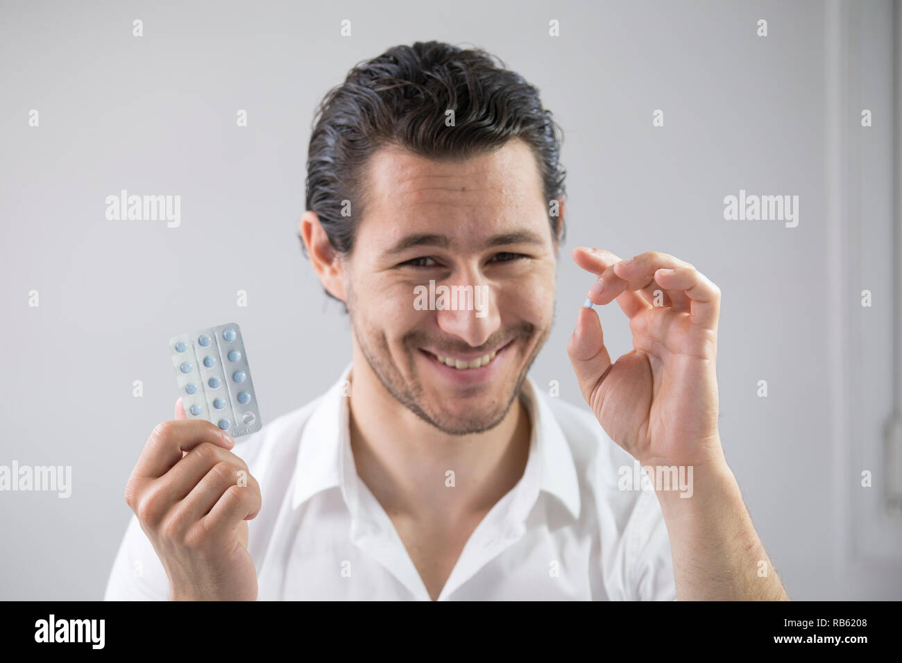 Man taking contraceptive pill Stock Photo - Alamy