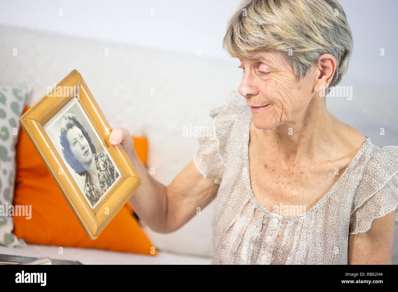 Old woman looking at photos Stock Photo - Alamy