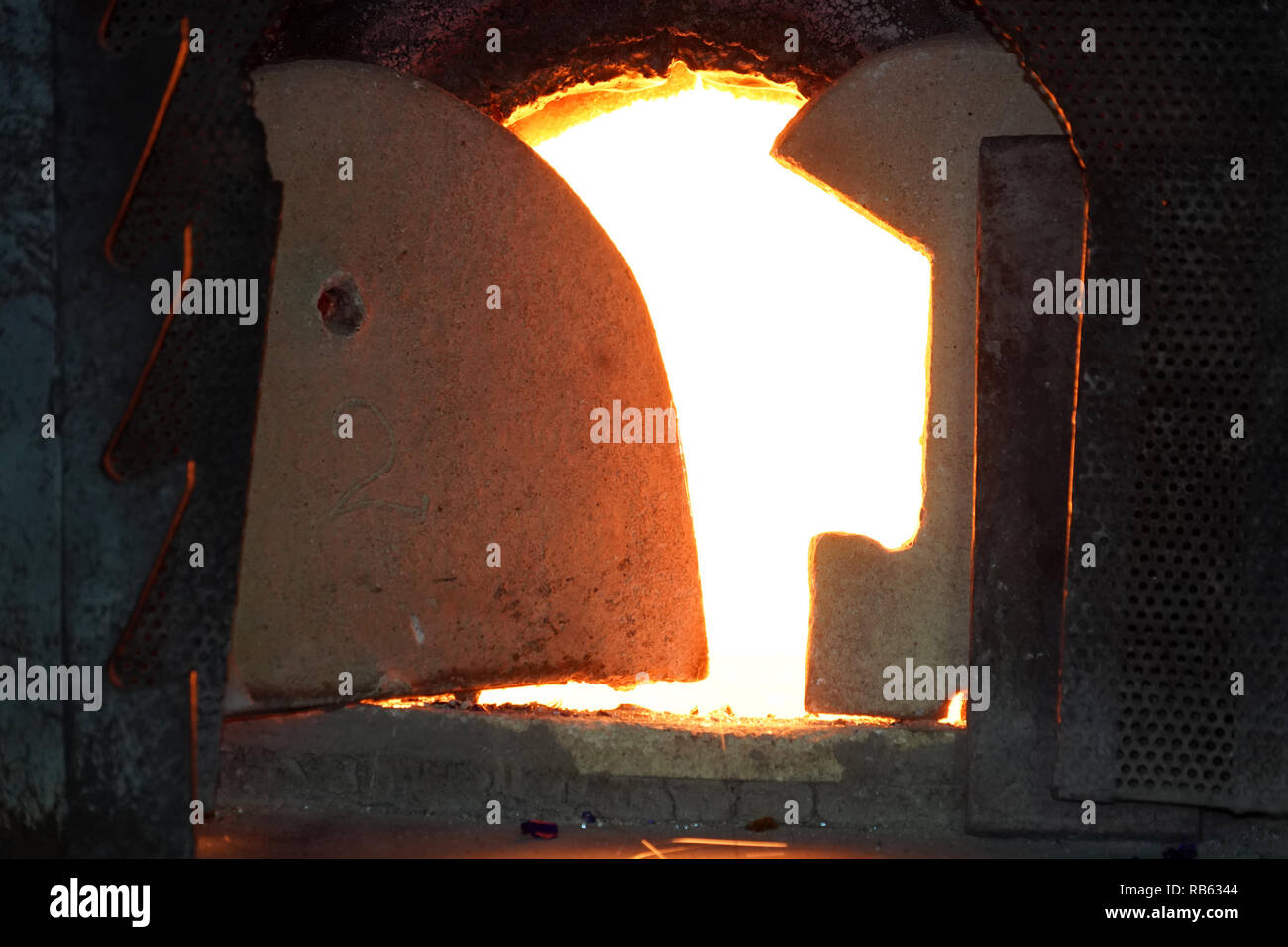 melted glass blow factory detail of work Stock Photo - Alamy