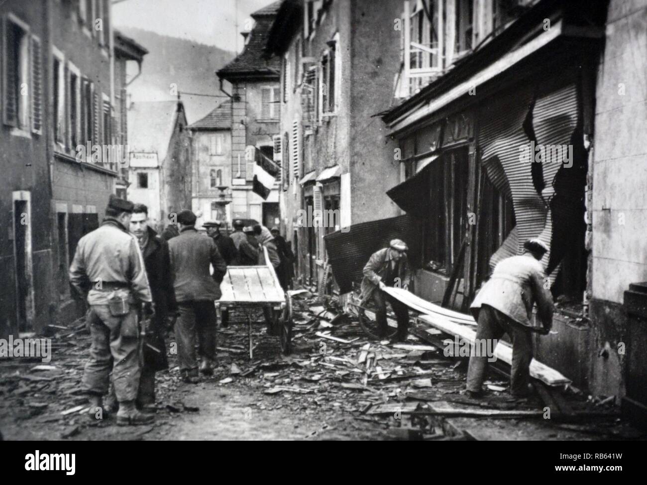 Citizens attempt to clear damaged buildings in Alsace Lorraine ...