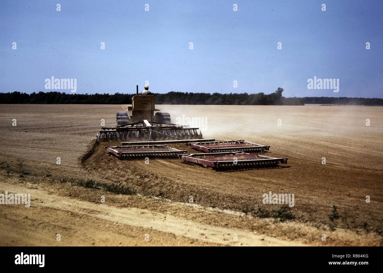 Photograph of a field being harrowed by a diesel tractor, Seabrook Farm ...