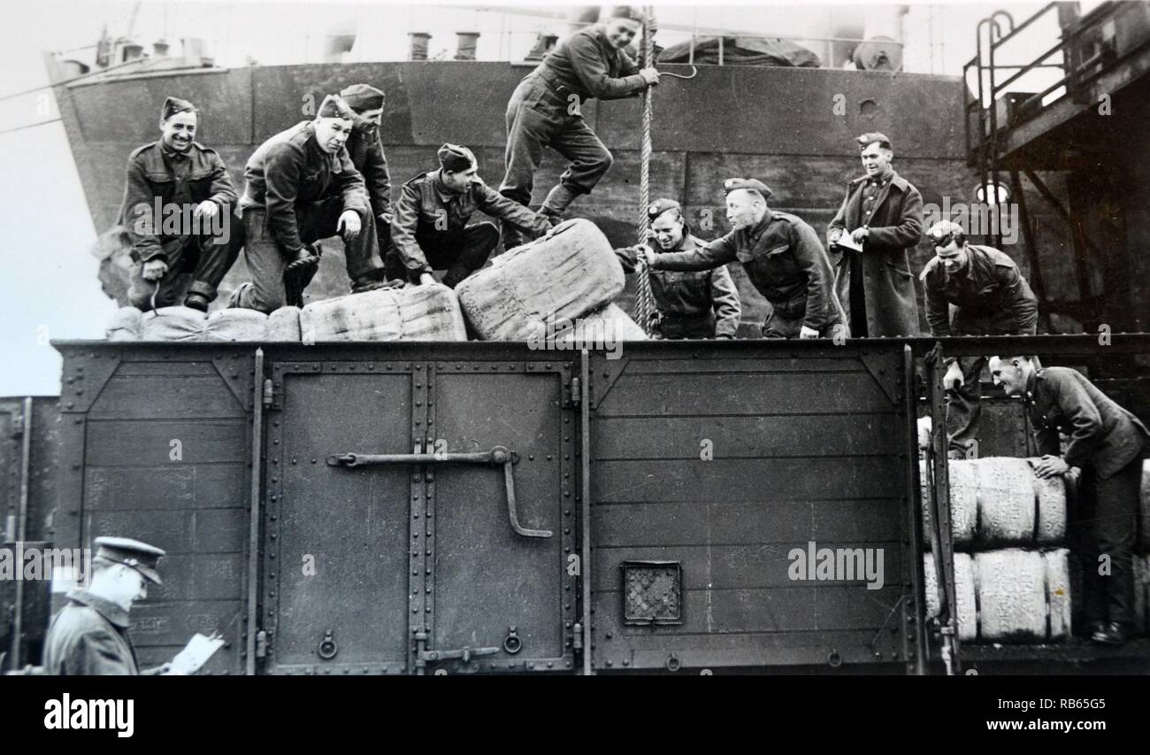 World War Two: British soldiers load supplies at a railway depot in ...