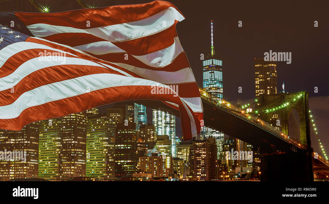U.S. Flag flying of Brooklyn Bridge waterfront with Manhattan skyline ...