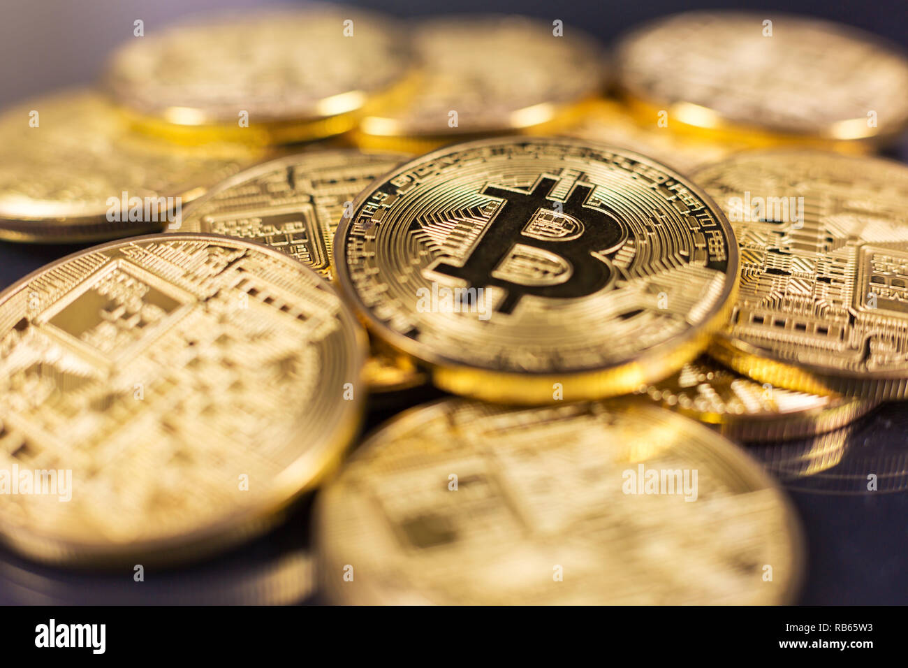 Stack of bitcoins lying on shiny dark surface Stock Photo - Alamy
