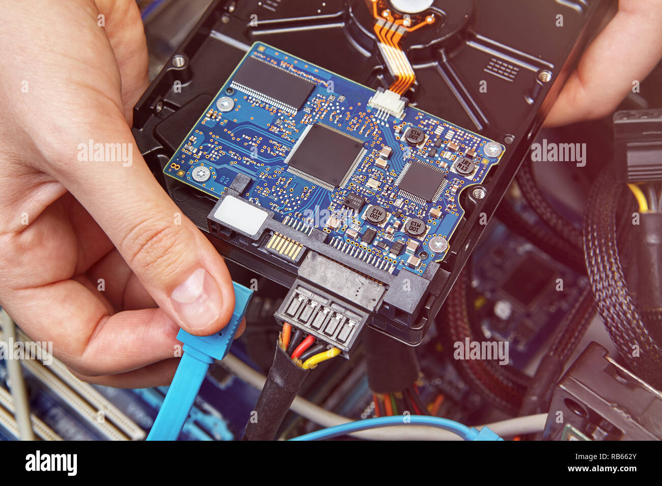 Connecting the HDD to the desktop PC with help of SATA cable blue Stock ...