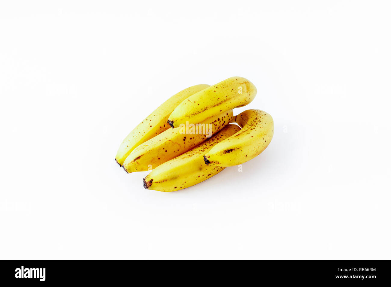 A bunch of five slightly overripe bananas isolated on a white ...
