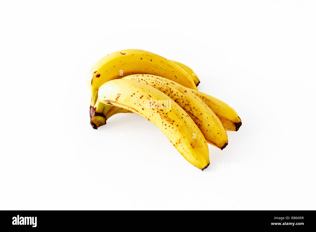 A bunch of five slightly overripe bananas isolated on a white ...