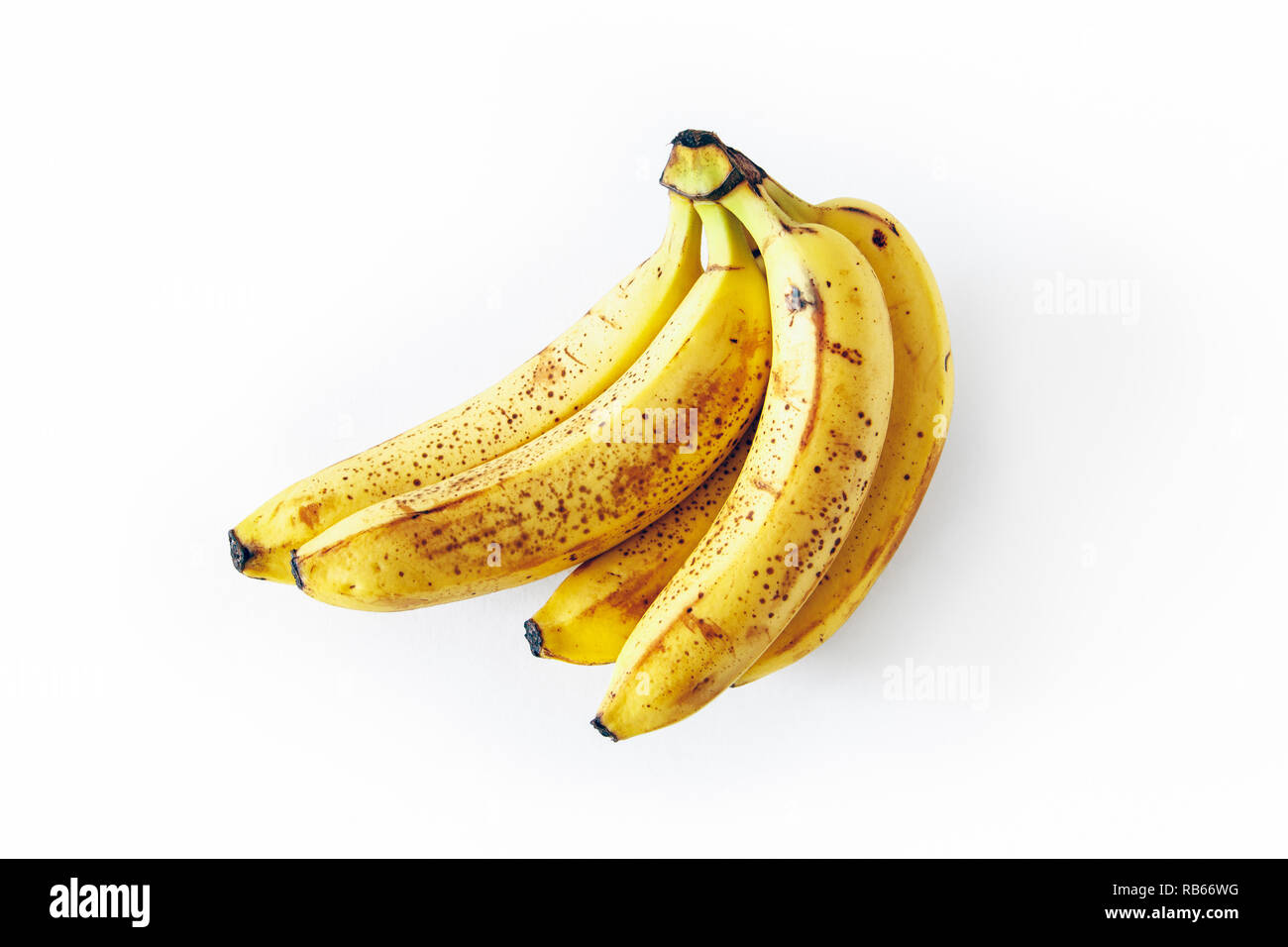 A bunch of five slightly overripe bananas isolated on a white ...