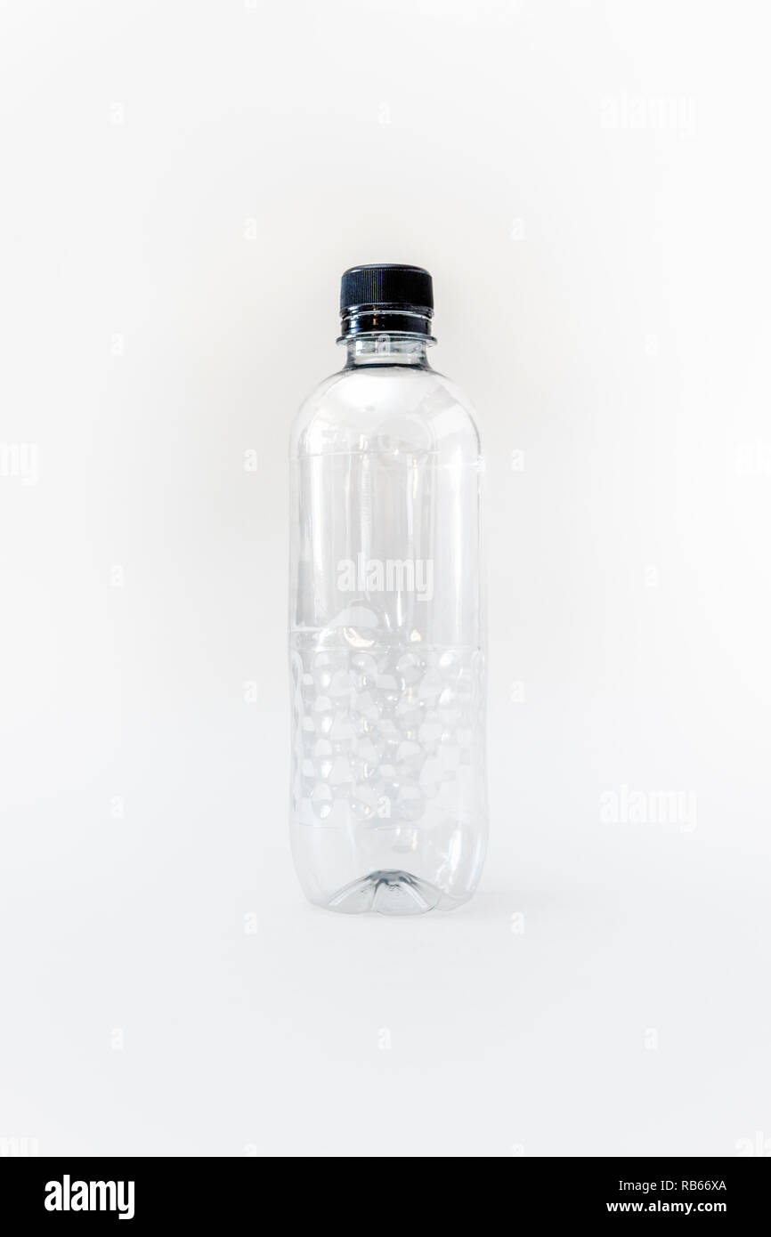 An empty generic single use plastic water bottle on a white background ...
