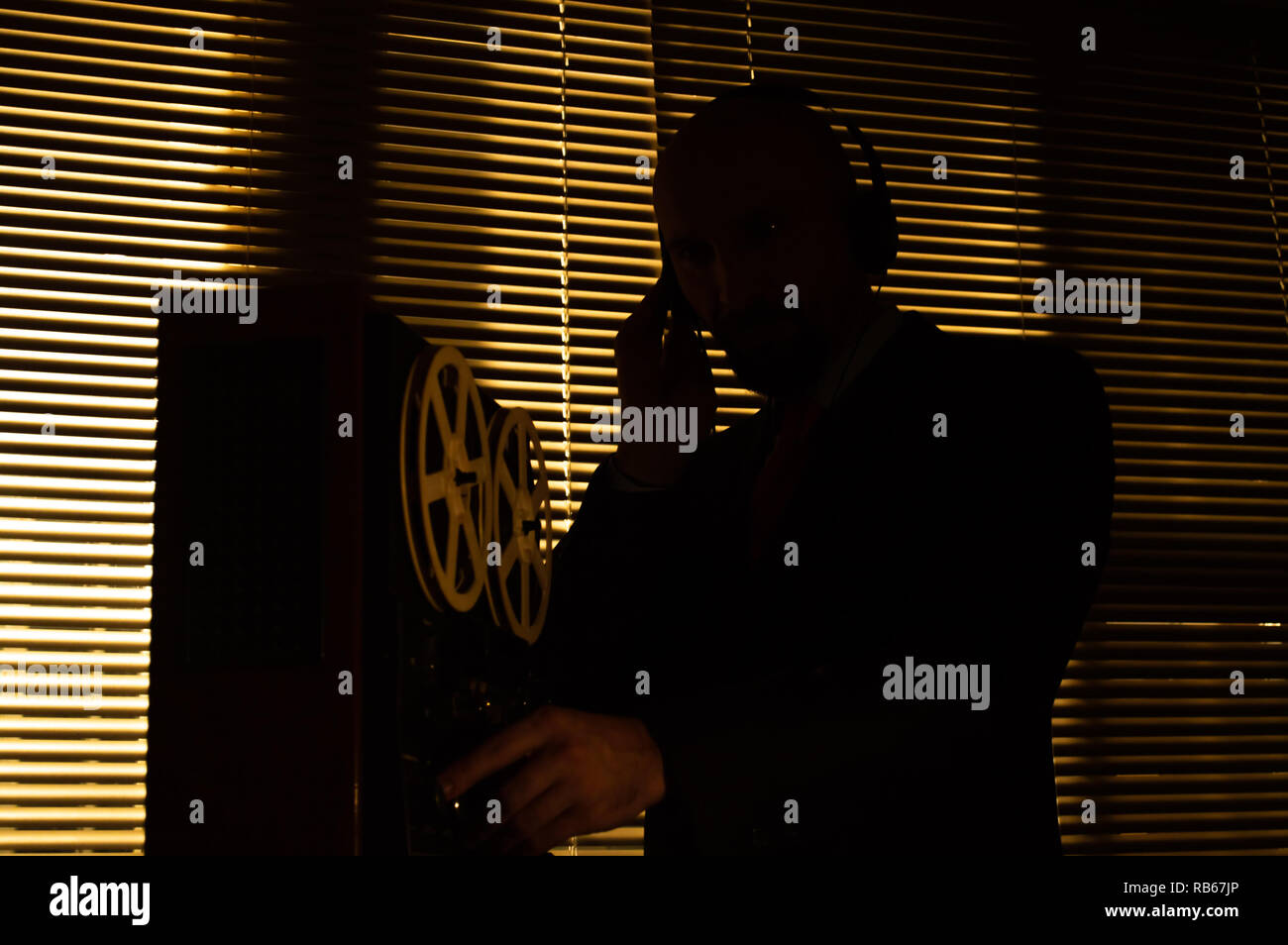 FBI agent eavesdropping on a directional microphone Stock Photo - Alamy