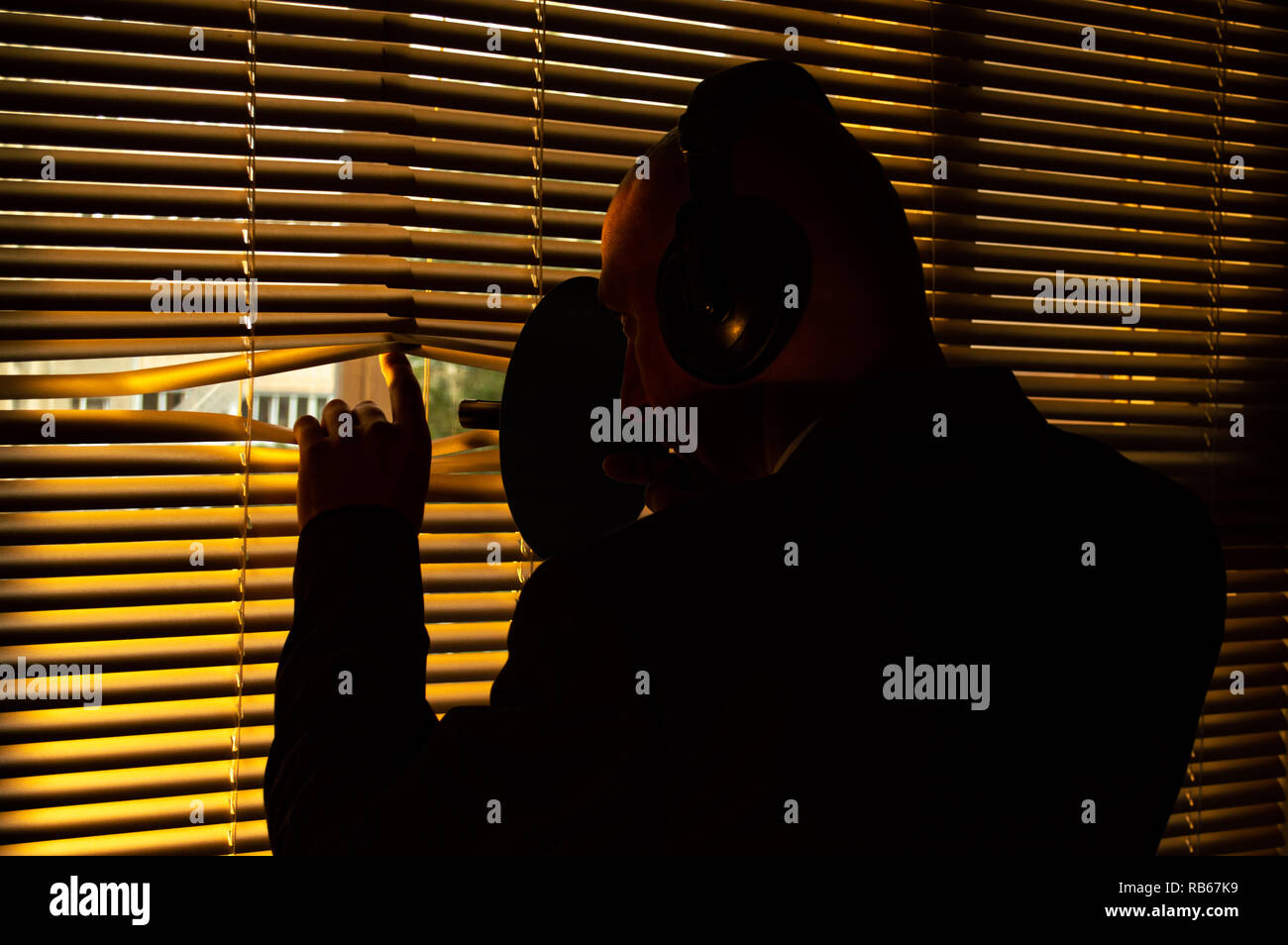 FBI agent eavesdropping on a directional microphone Stock Photo - Alamy