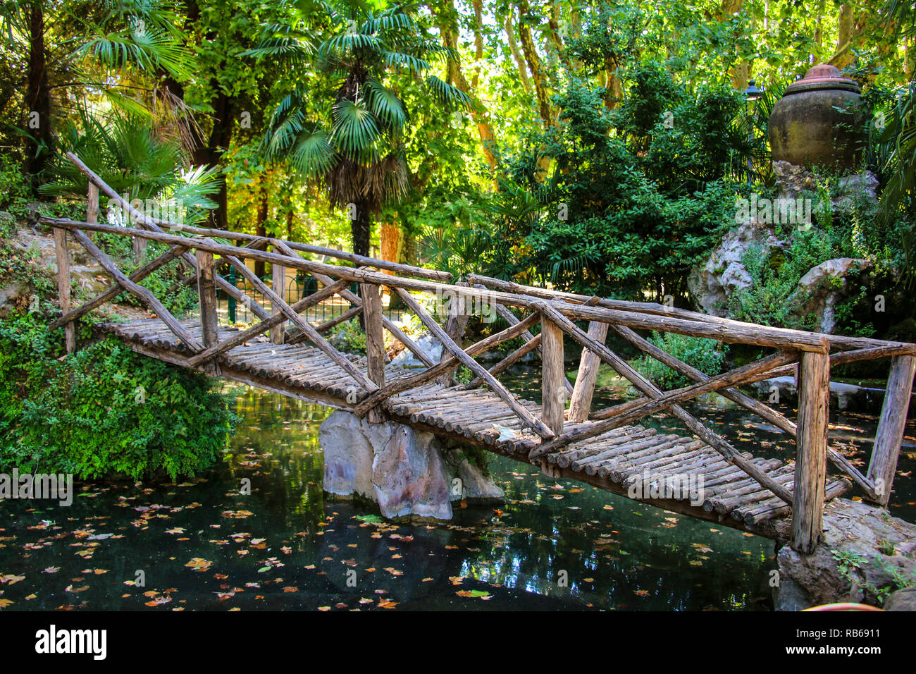 wooden bridge over a pond in one of the parks Stock Photo - Alamy