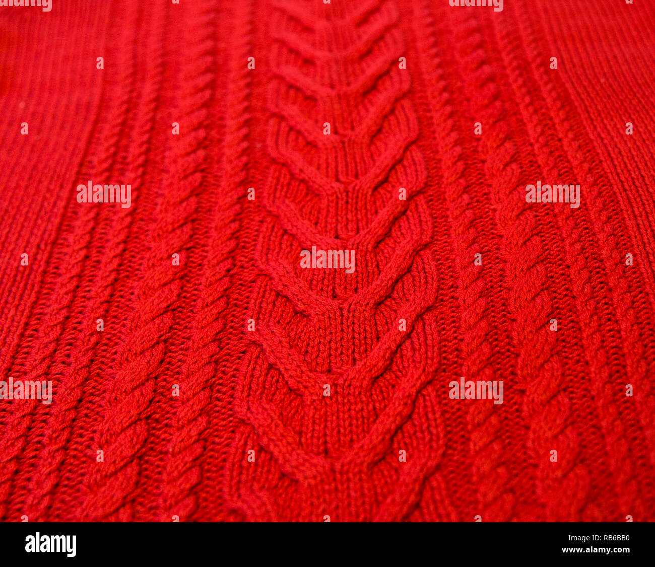 Red Knitted pattern wool sweater texture close up. Handmade red ...