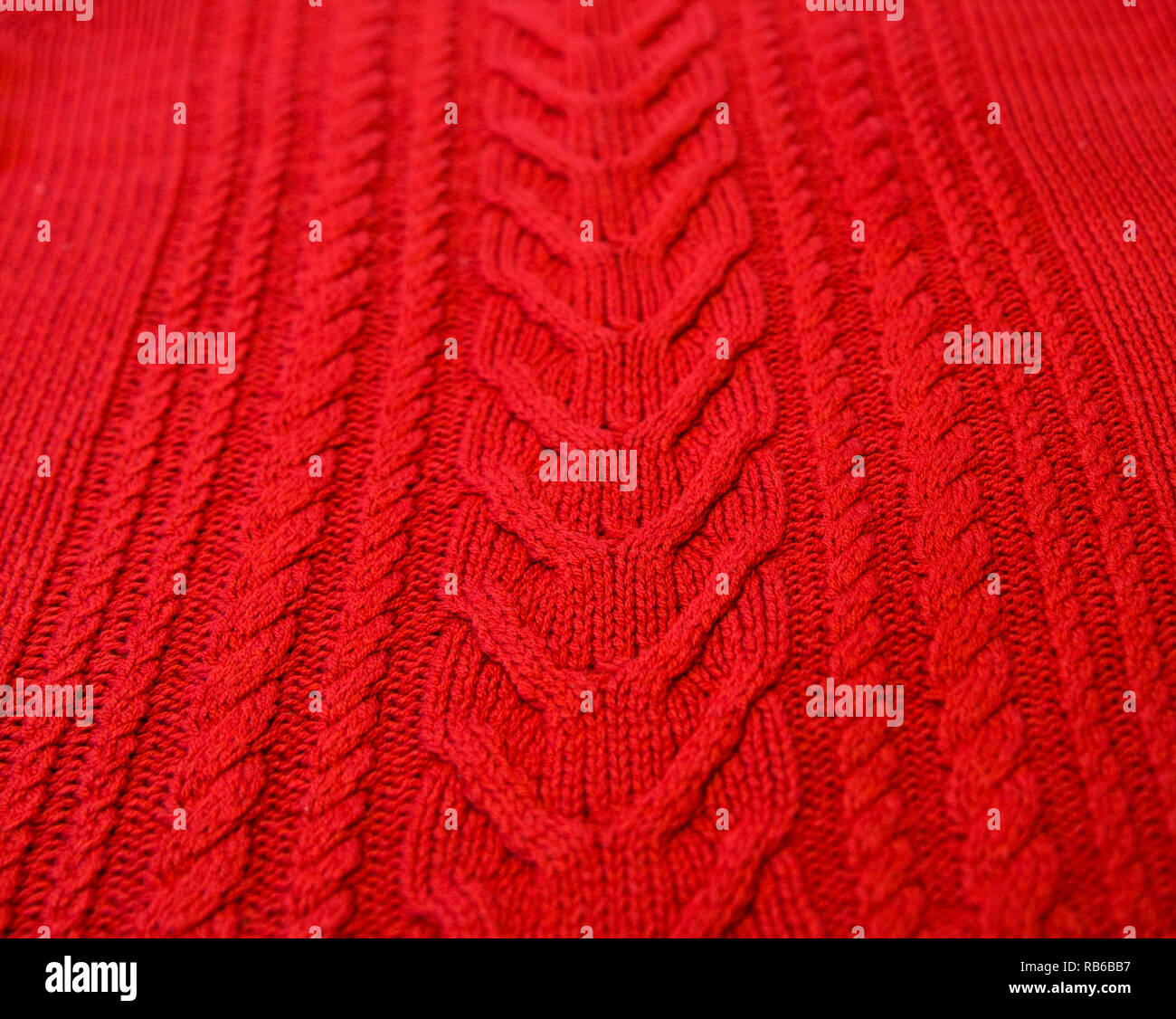 Red Knitted pattern wool sweater texture close up. Handmade red ...