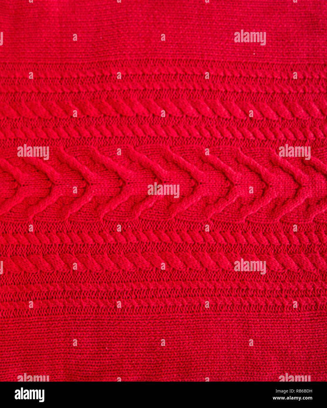 Red Knitted pattern wool sweater texture close up. Handmade red ...