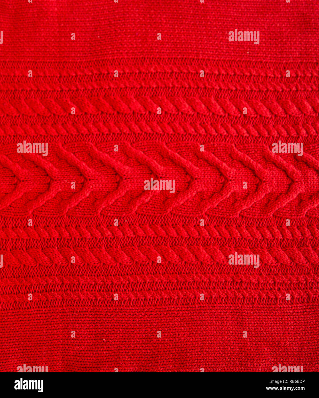 Red Knitted pattern wool sweater texture close up. Handmade red ...