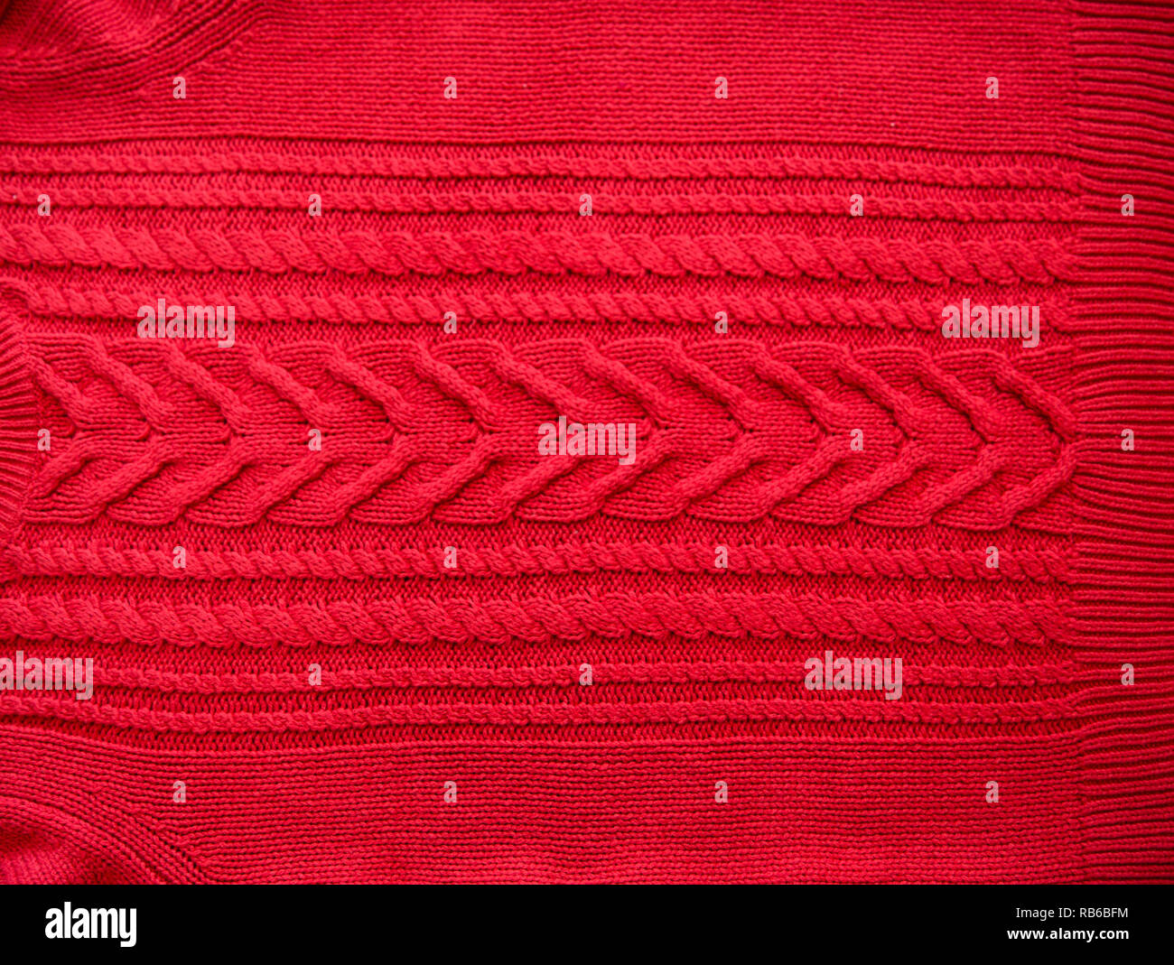 Red Knitted pattern wool sweater texture close up. Handmade red ...