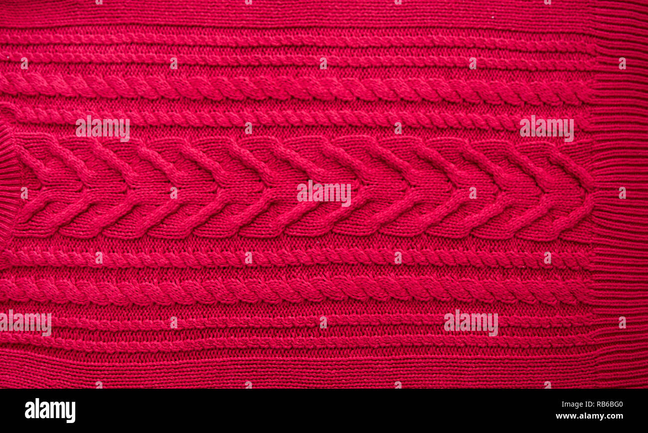 Red Knitted pattern wool sweater texture close up. Handmade red ...
