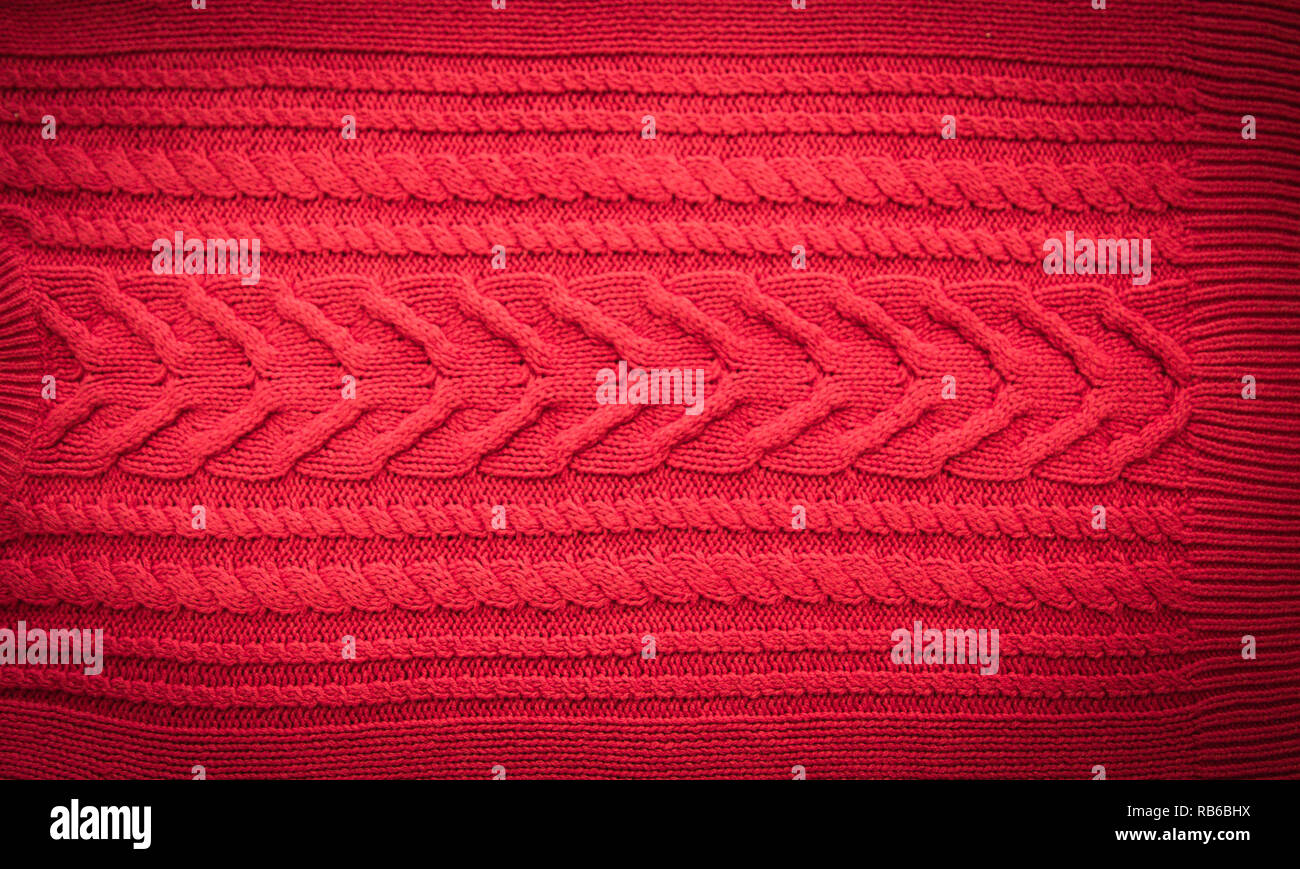 Red Knitted pattern wool sweater texture close up. Handmade red ...